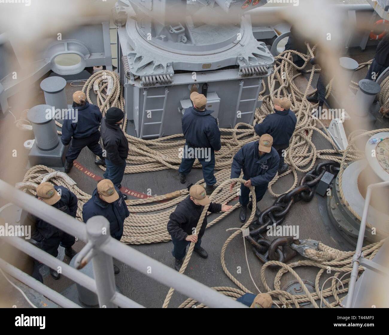 NORFOLK, Va. (Feb. 20, 2019) Sailors fake down mooring lines during a ...