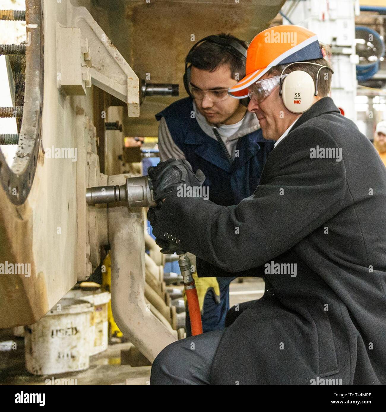 Secretary of the Army Mark T. Esper operates an impact wrench to remove ...
