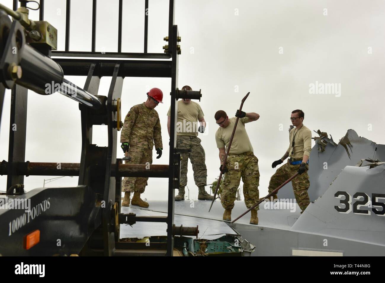 Airmen form the 325th Maintenance Squadron prepare to disassemble and ...