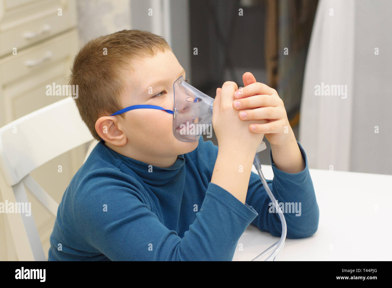the boy treats a cold with an inhaler Stock Photo - Alamy