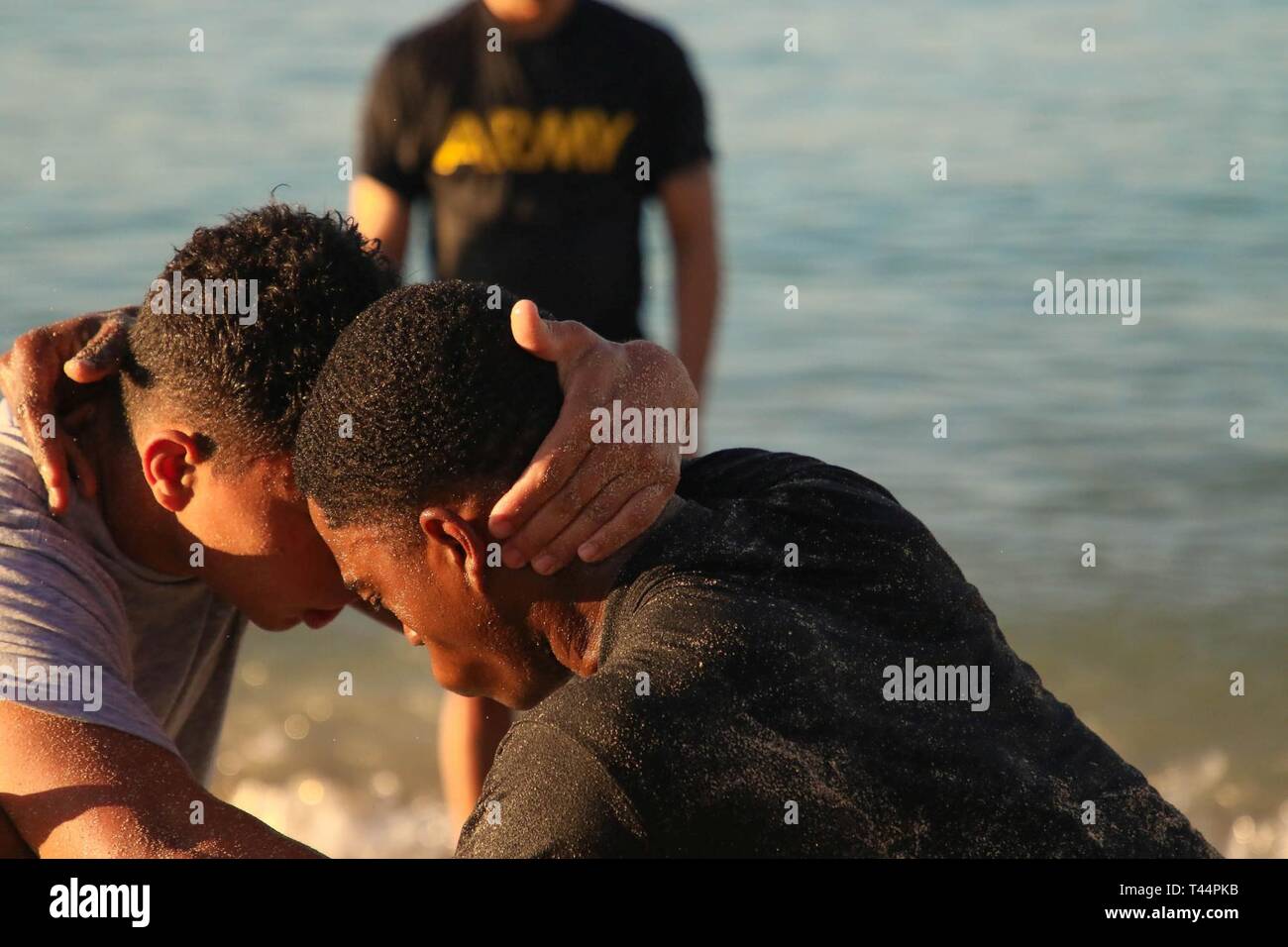 A U.S. Soldier and Airman are headlock as they perform combative drills ...