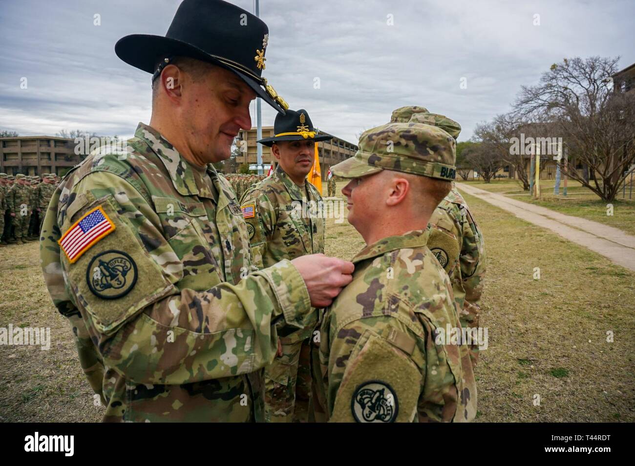 Lt. Col. Alex Lee awards the combat medical badge to Spc. Cory Burbage ...