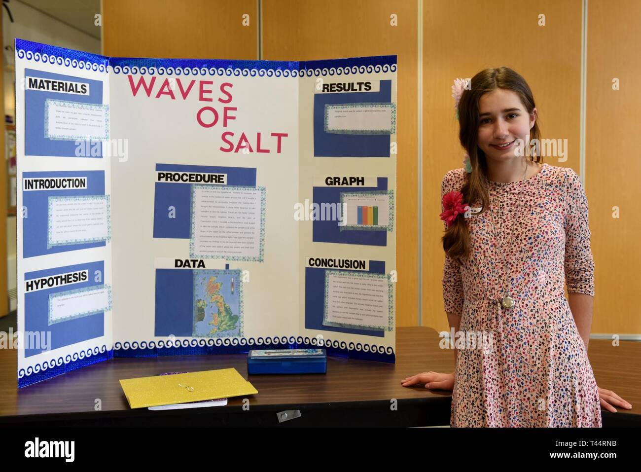 Student Emma Higgins poses for a photo next to her science fair project ...