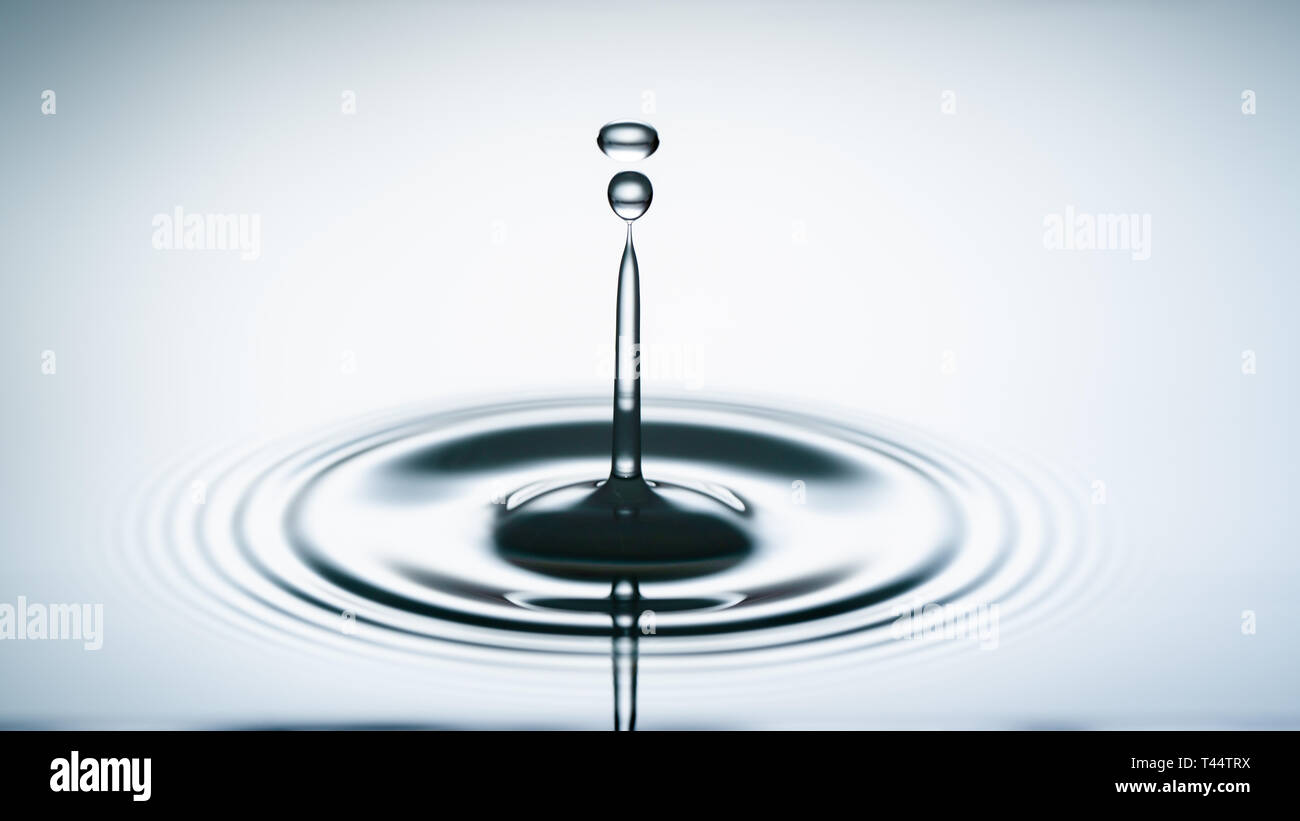 Water drop falling on water surface hi-res stock photography and images ...