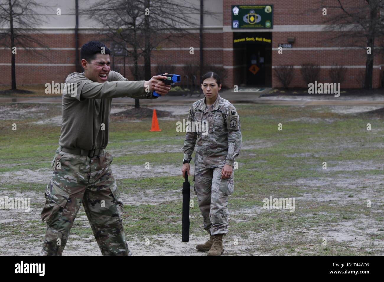 Left: Pvt. Issac Ceron, 21st MP Company (Airbone) , aims a taser at a ...