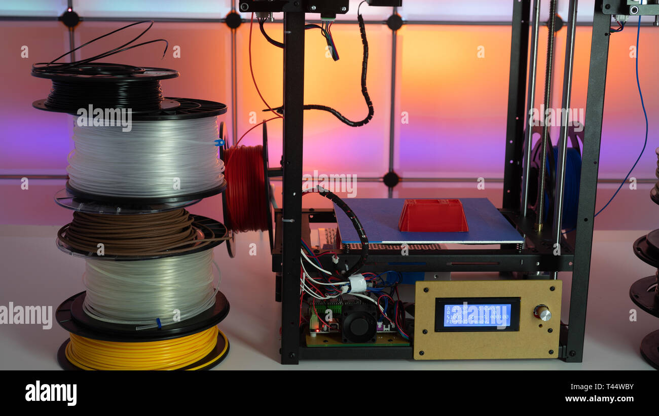 3d printer and plastic filament on color background Stock Photo - Alamy