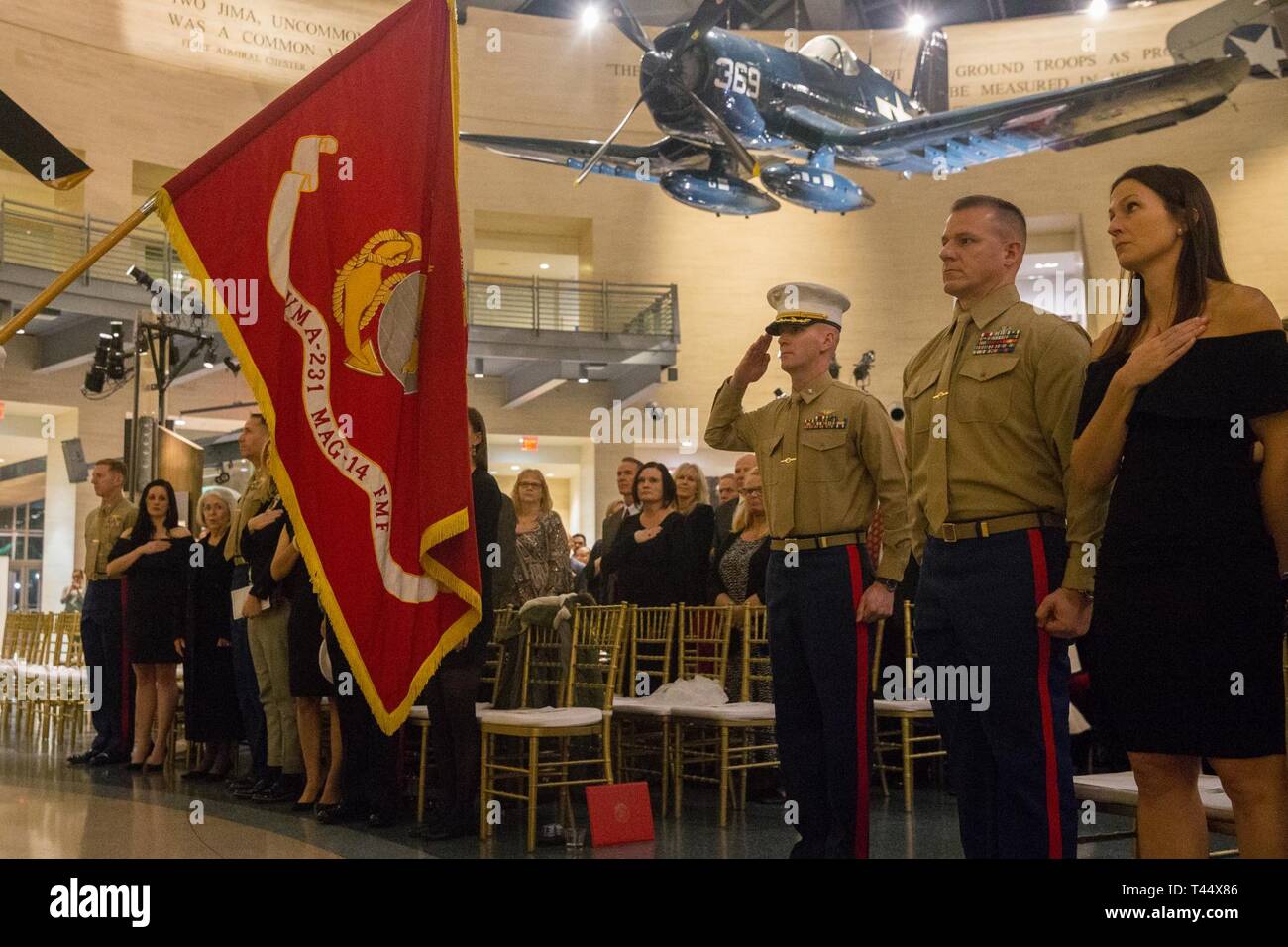 U.S. Marine Lt. Col. Eric Grunke, right, salutes the colors during the ...