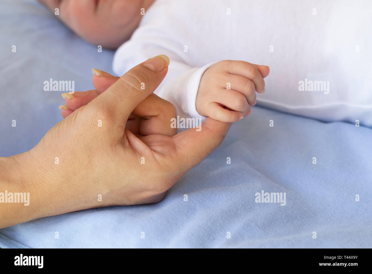 Baby baby holding the mother finger, maternity concept Stock Photo - Alamy