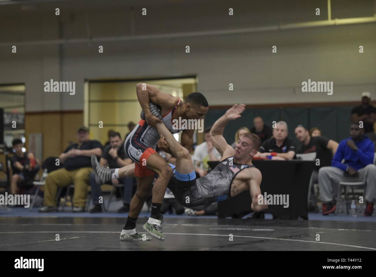 SPC Leslie Fuenffinger of the Army scores a powerful takedown of 1stLt ...
