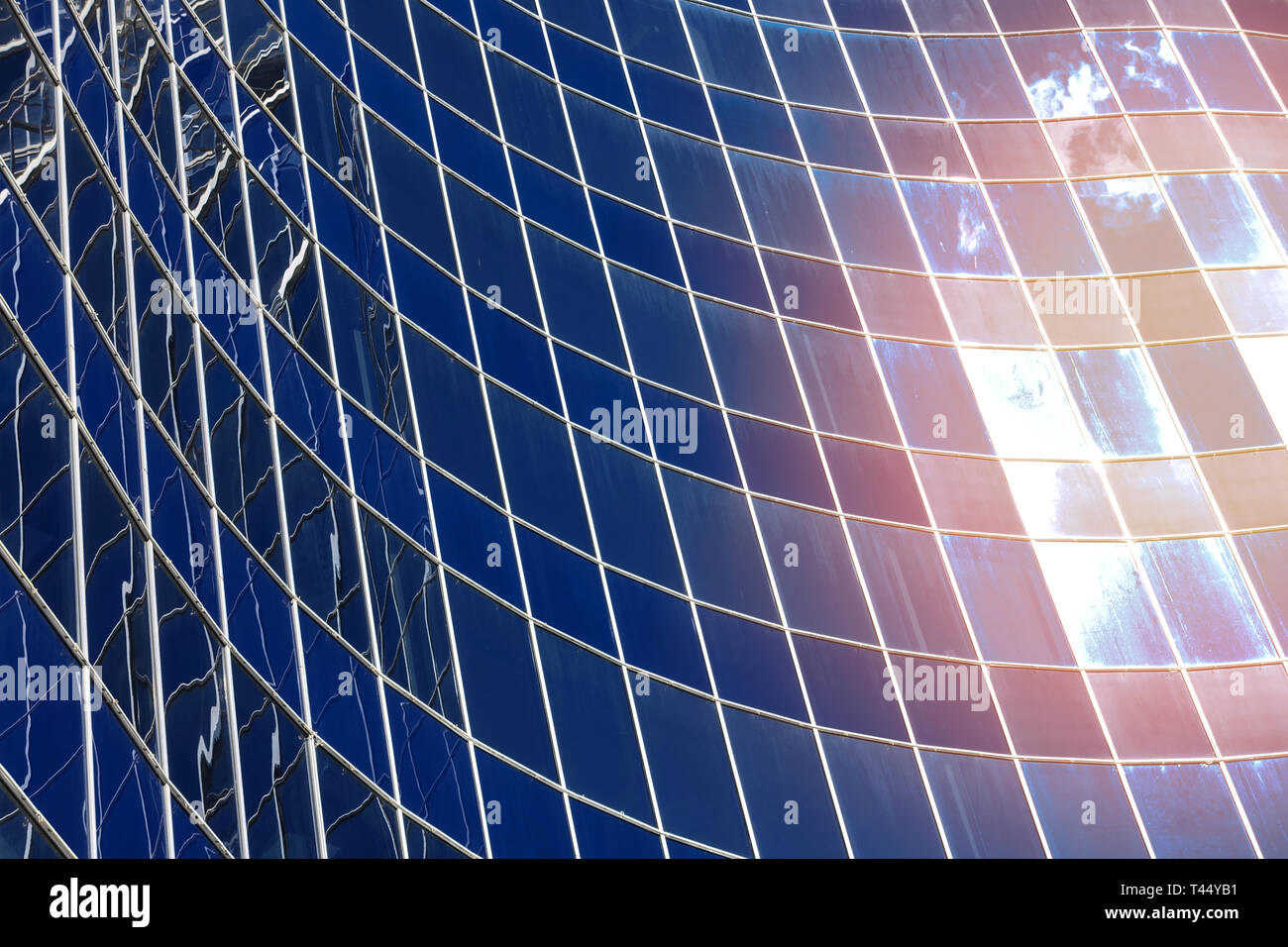 many mirrored windows on the facade of modern business building. sky ...
