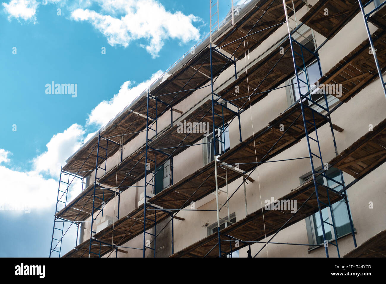 repair of building facade building in the city. blue sky background ...