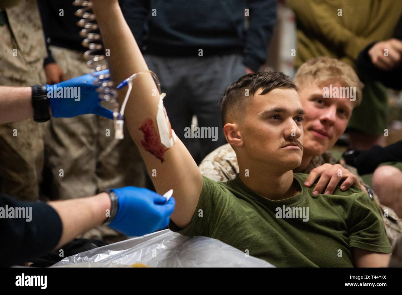 U.S. Marine Corps Lance Cpl. Caleb Sauble receives an IV from Gunnery ...