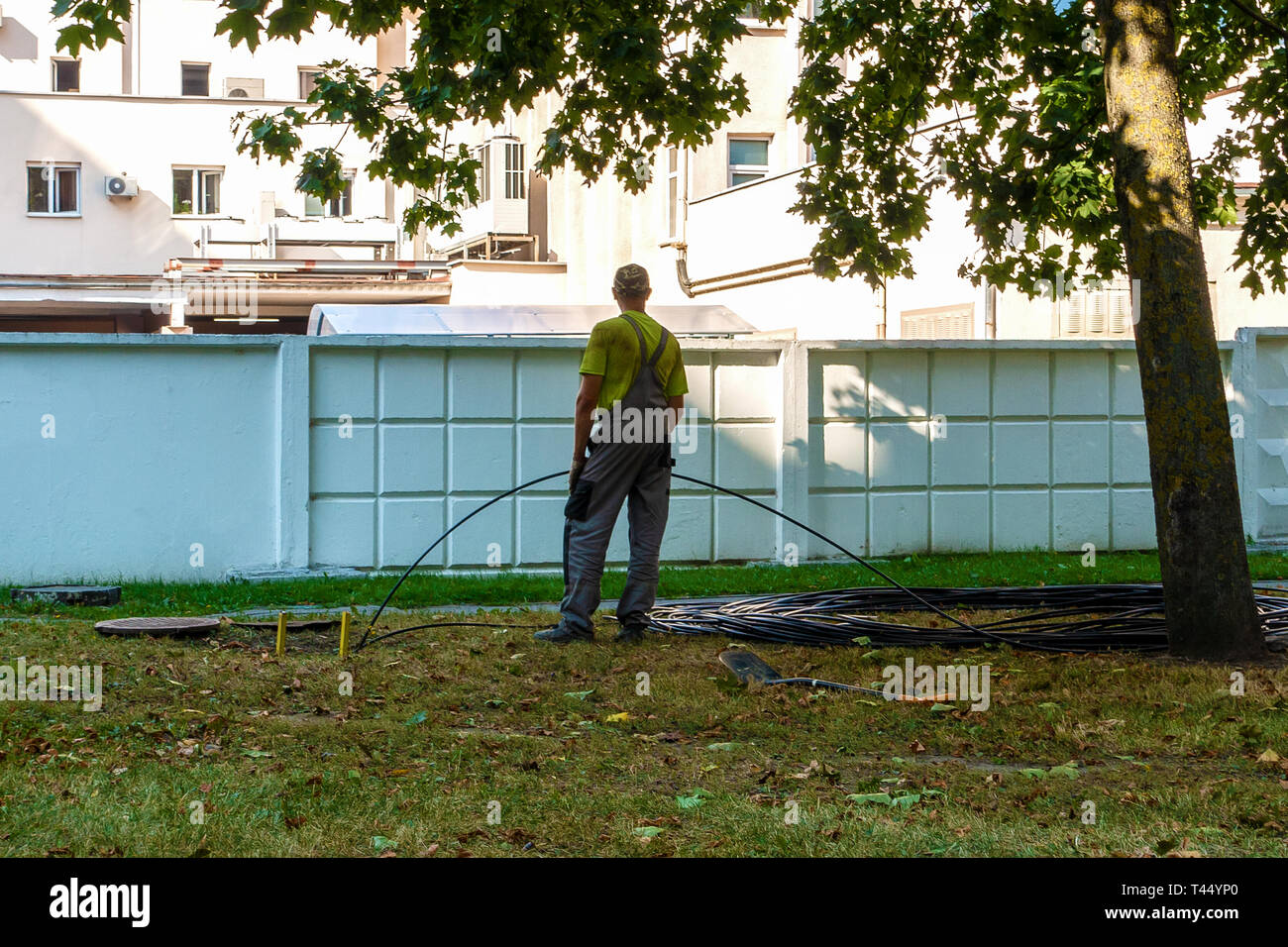 Man holding hose hi-res stock photography and images - Alamy