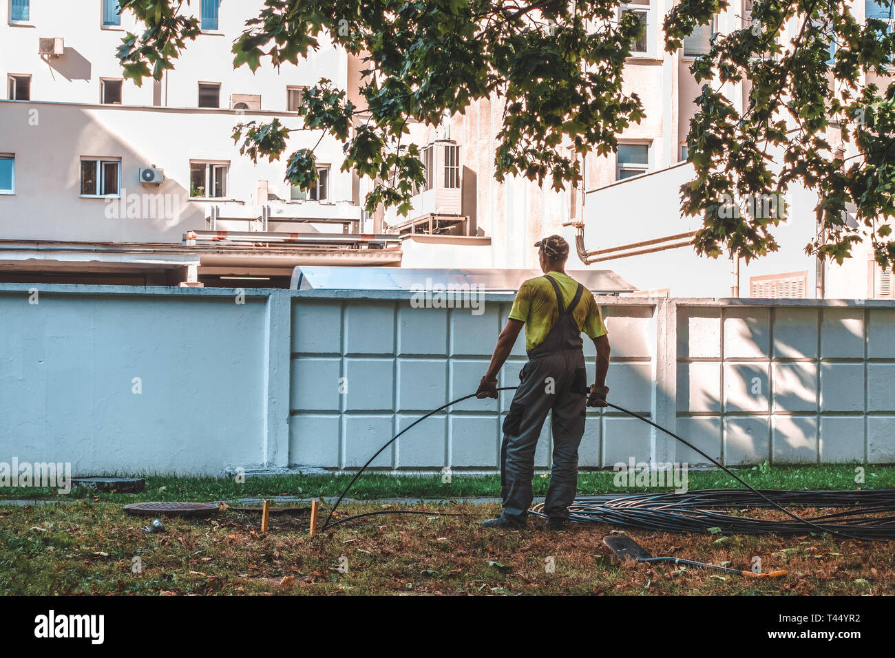 Man holding hose hi-res stock photography and images - Alamy