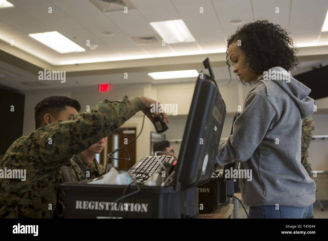 Marines register a staged evacuee at a checkpoint during a simulated ...