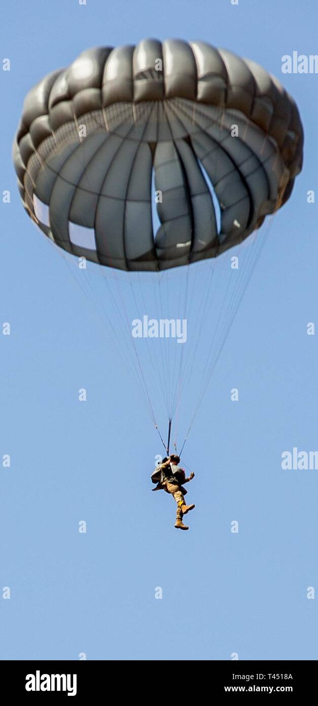 A Group of U.S. Army Paratroopers parachute onto Bobo-Dioulasso Drop ...