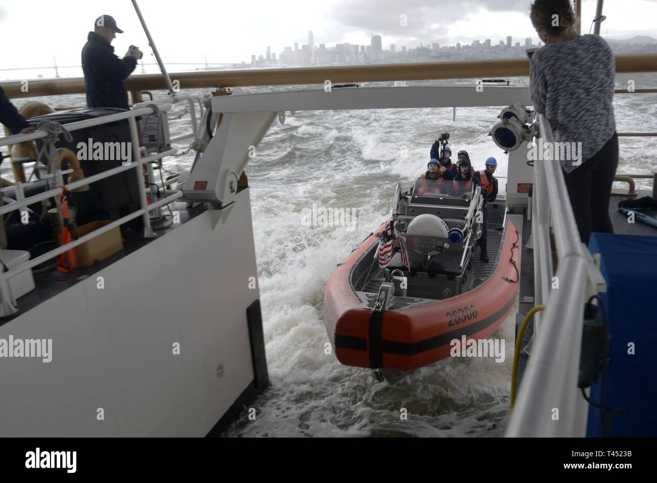 Crewmembers aboard a 26-foot Over the Horizon IV Cutter Boat enter the ...
