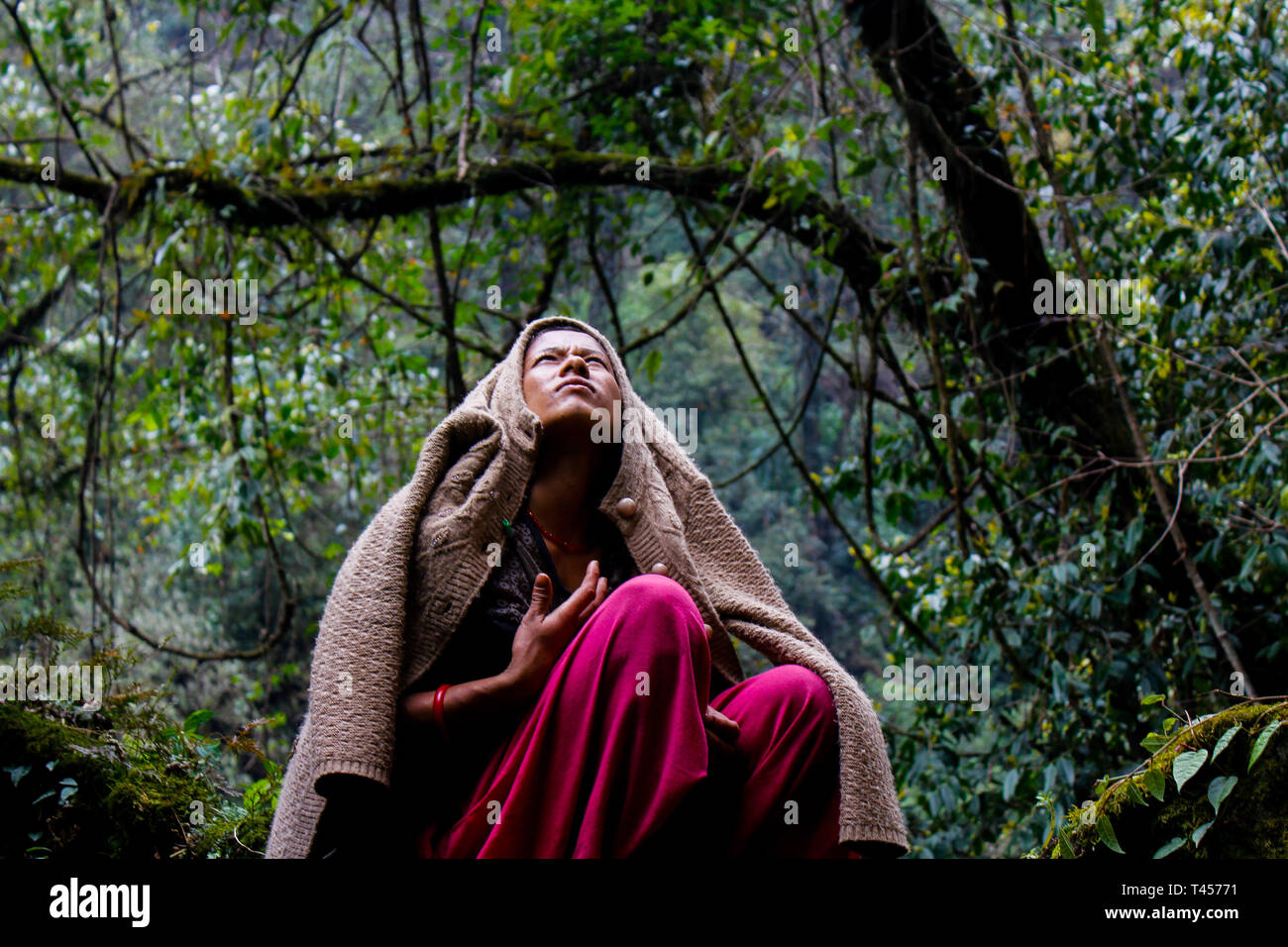 Siding, kaski, Nepal. 11th Apr, 2019. A woman seen covered up watching ...