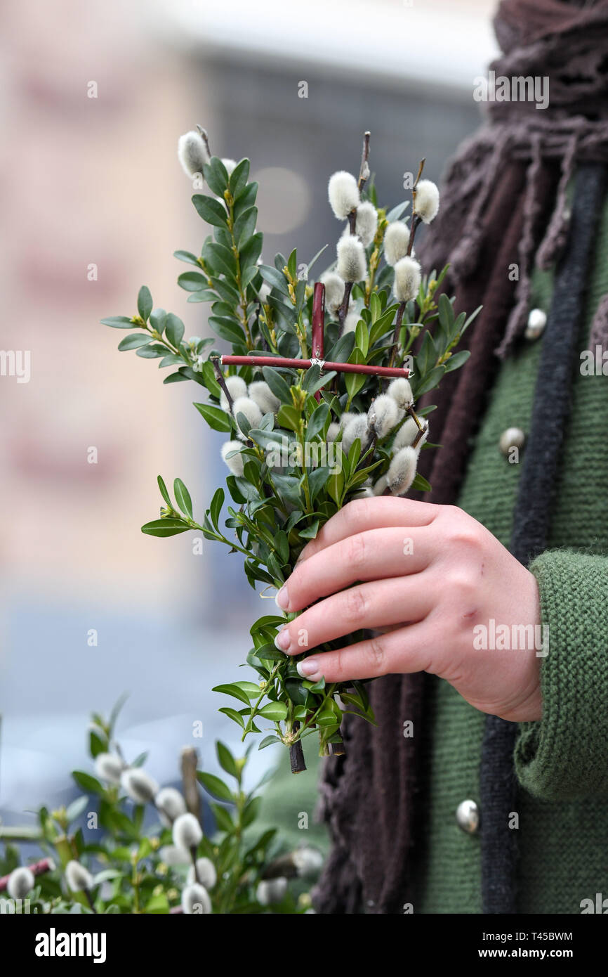 Bad Tölz, Germany. 14th Apr 2019. A girl is holding a palm bush in the ...