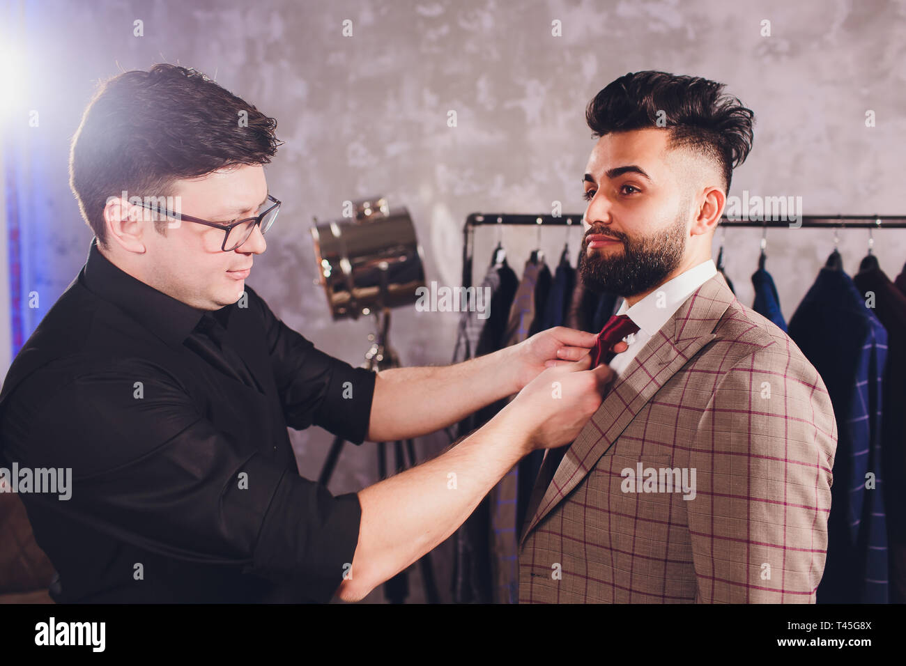 Mature professional Tailor taking measurements for sewing suit at ...