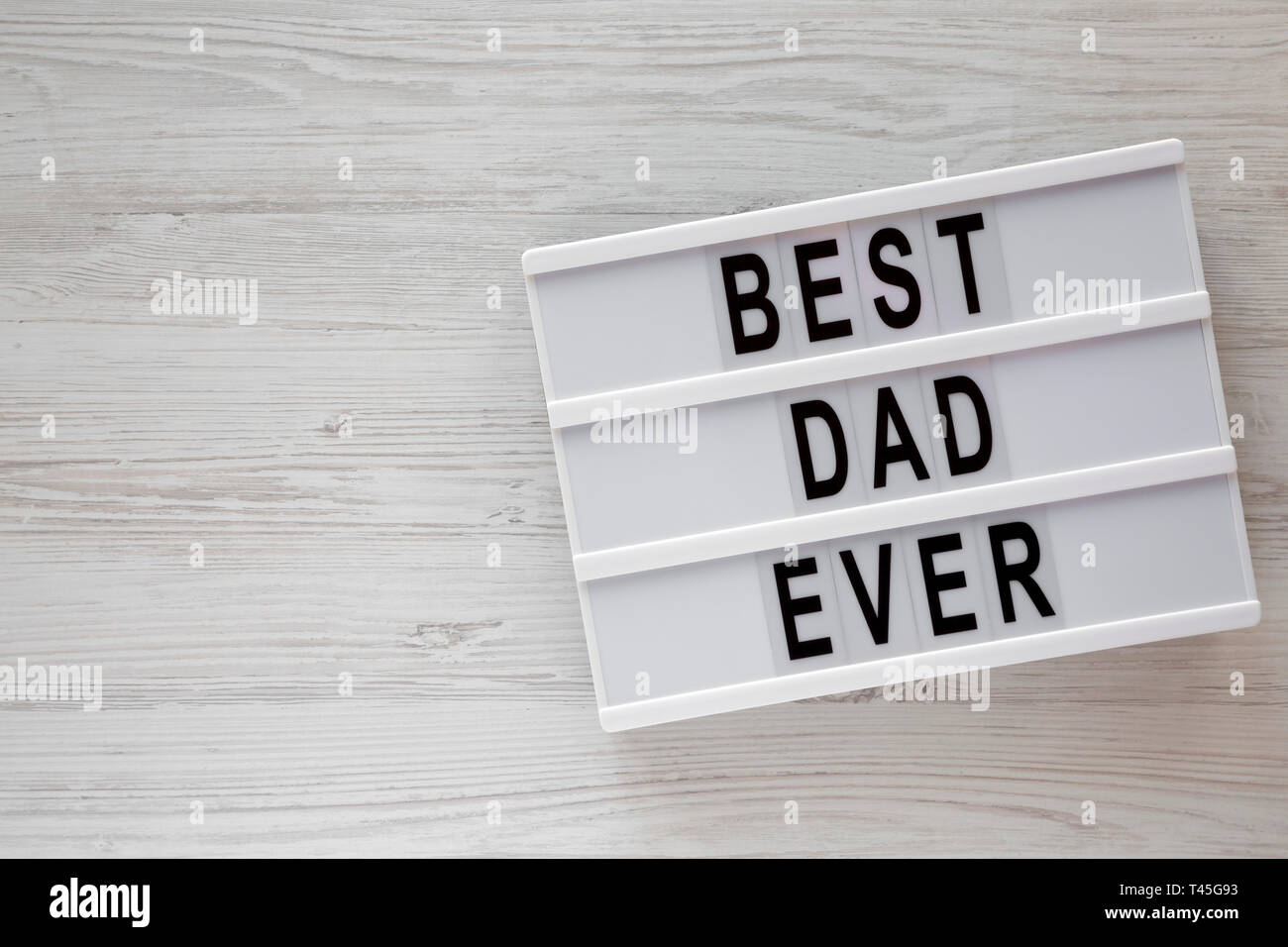 'Best dad ever' words on modern board over white wooden surface, top ...