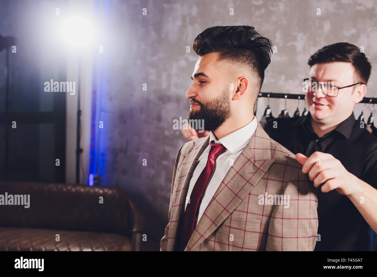 Mature professional Tailor taking measurements for sewing suit at ...