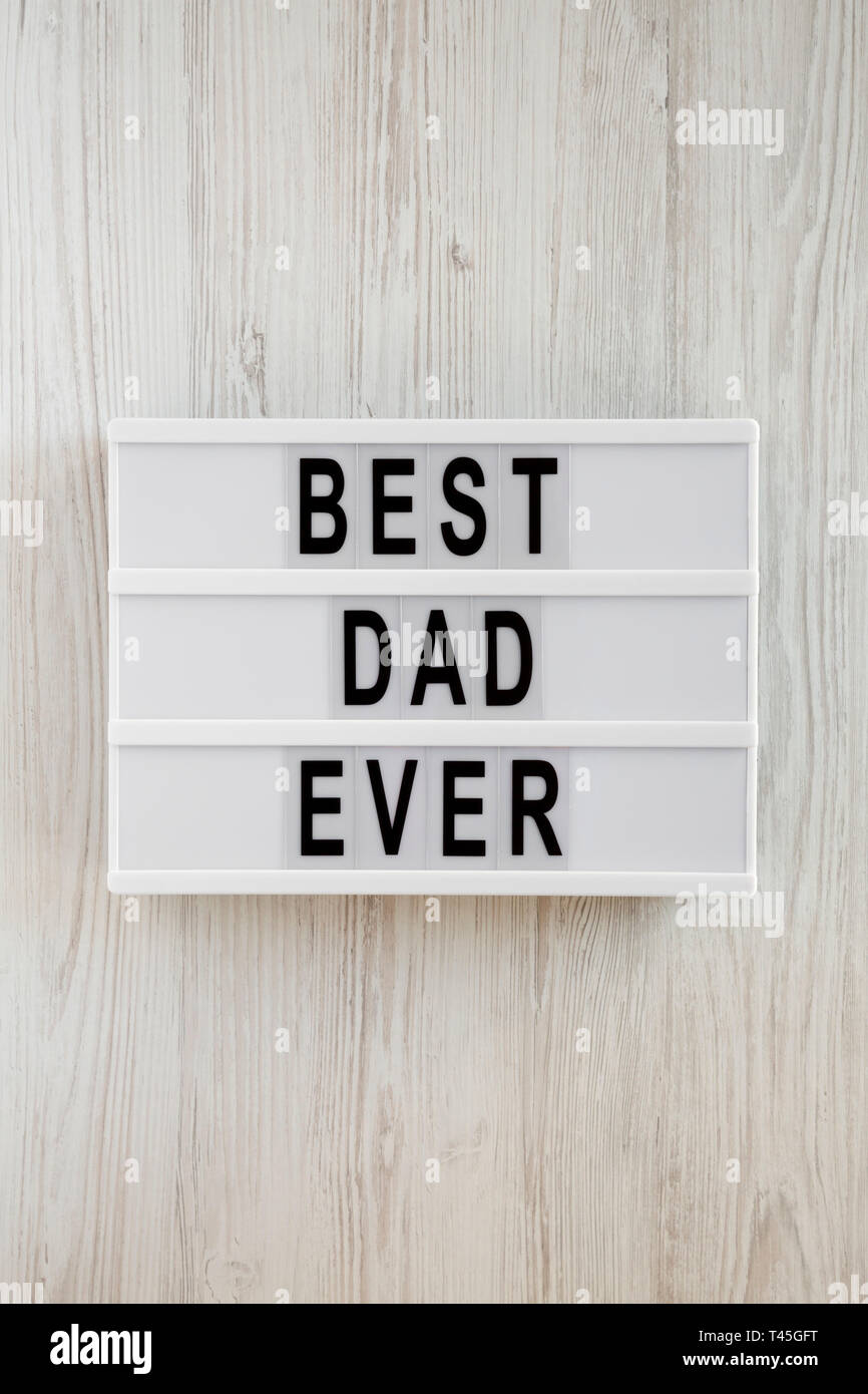 'Best dad ever' words on lightbox over white wooden background, top ...