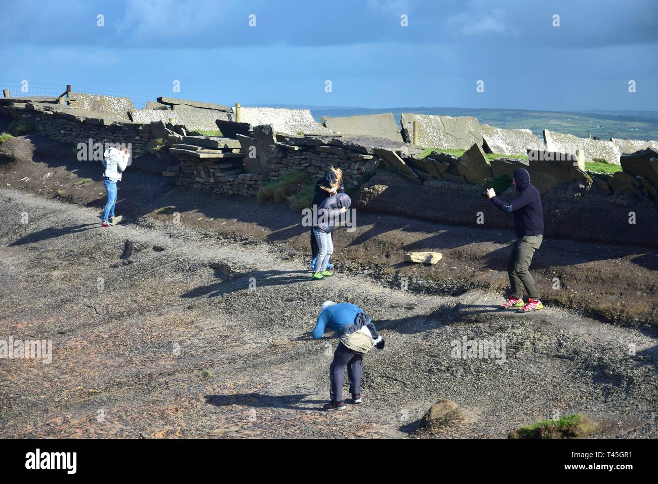 People fighting against very strong wind on an exposed spot on the ...