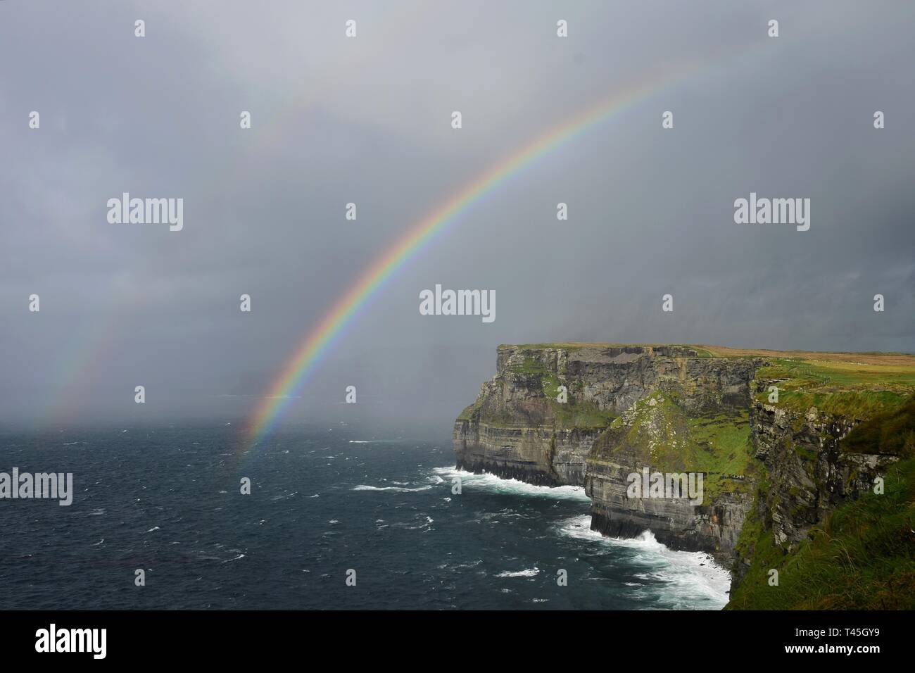 A rainbow over the Cliffs of Moher on the west coast of Ireland in ...