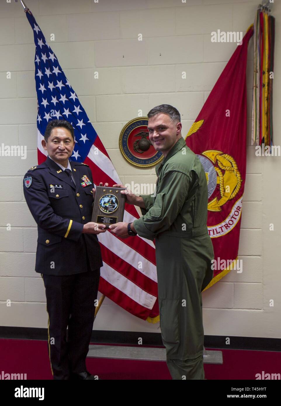Col. Takaoka (left) presents Maj. Mark A. Stefanski (right) with a ...