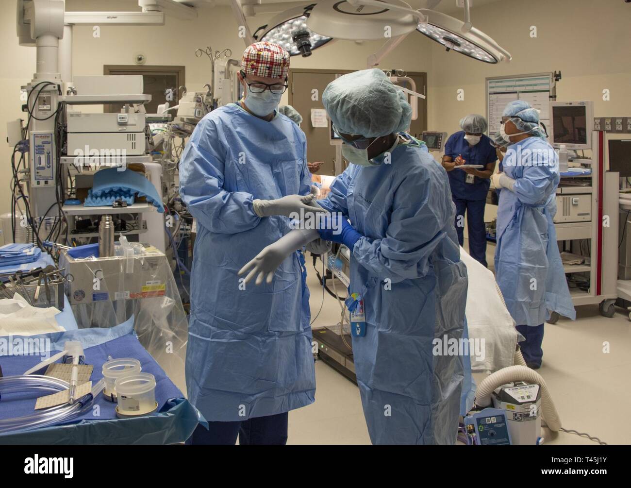 Dr. Saudra Kabagamba, civilian resident, is assisted by Senior Airman ...