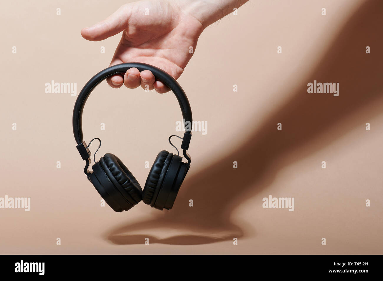 Hand headphone hi-res stock photography and images - Alamy