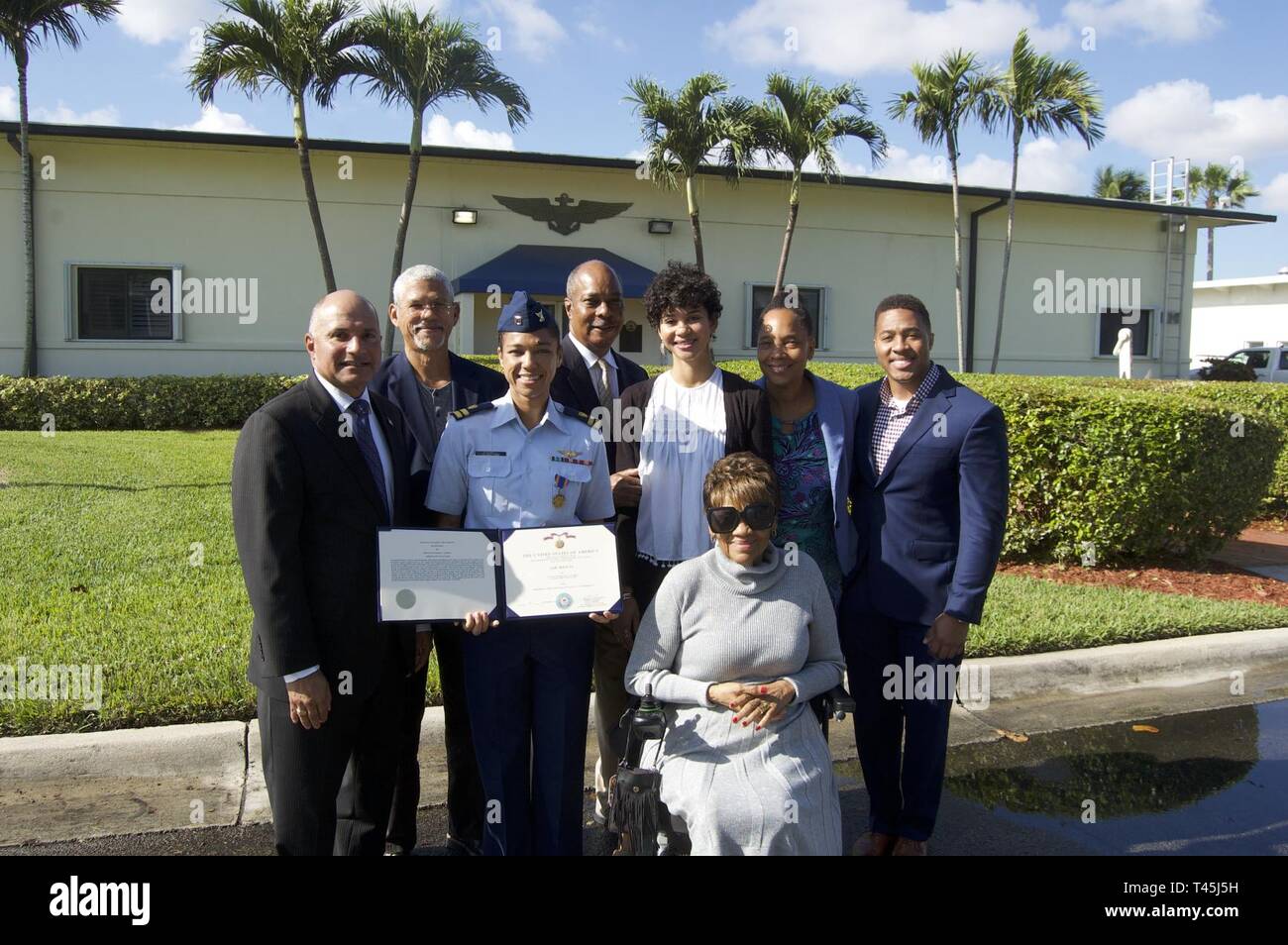 Coast Guard Lt. Ronaqua Russell stands with her family and Coast Guard ...
