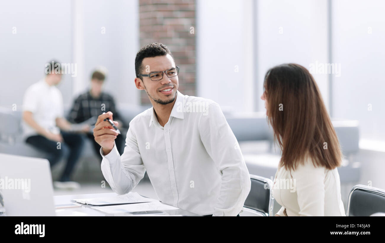 business people discussing the terms of the contract sitting at the ...