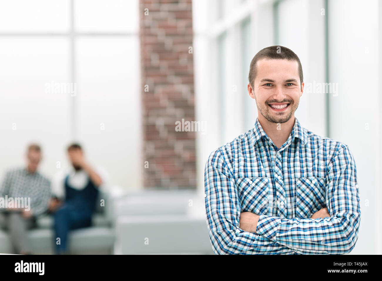 young employee on the background of the office .photo with copy space ...
