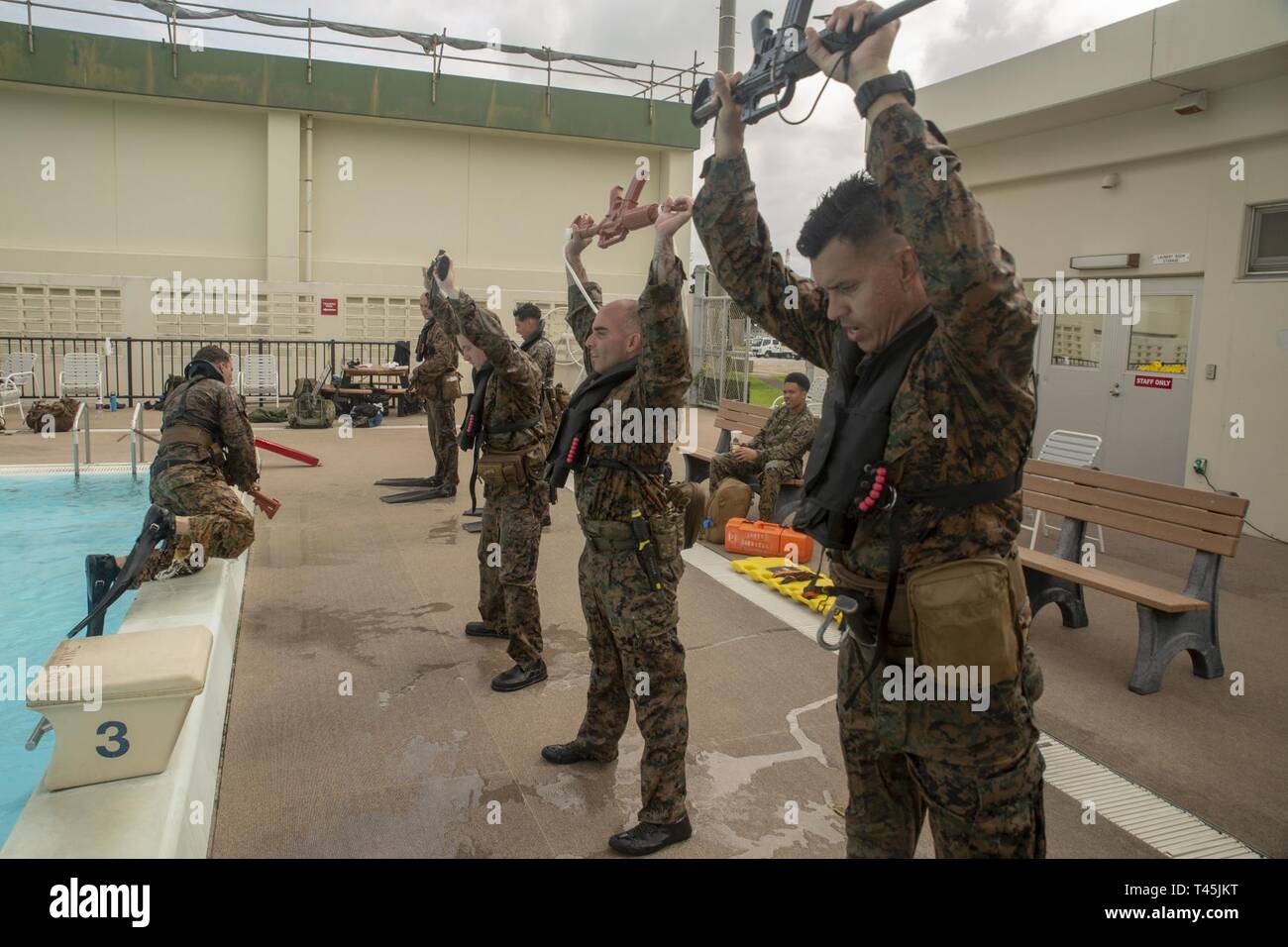 U.S. Marines and Sailors exercise outside of the pool during a Scout ...
