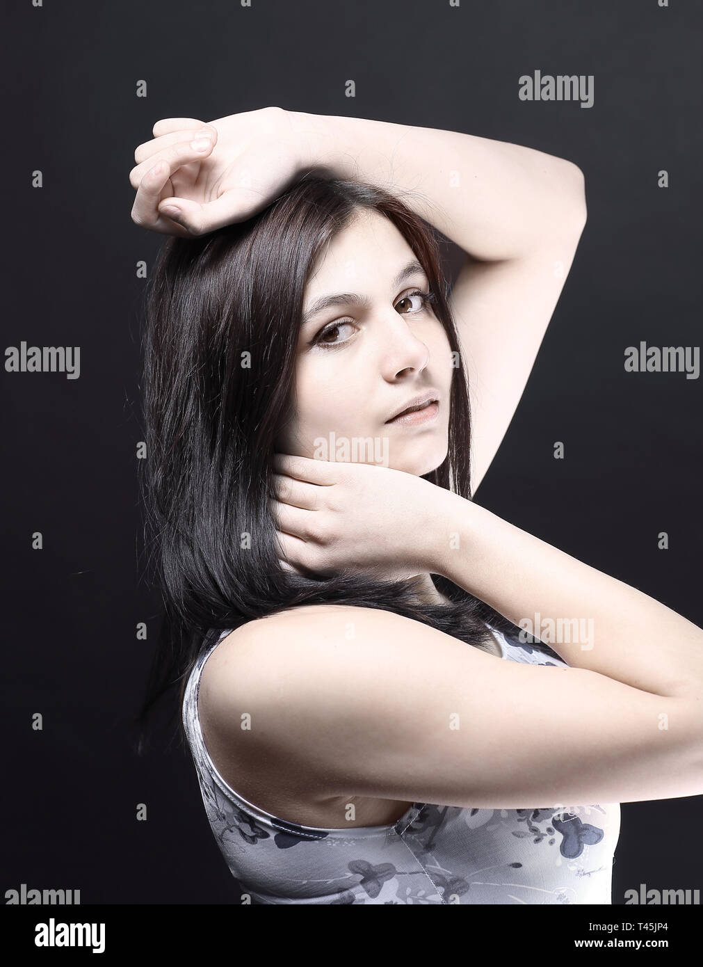 portrait of a modern girl posing for the camera.isolated on dark ...