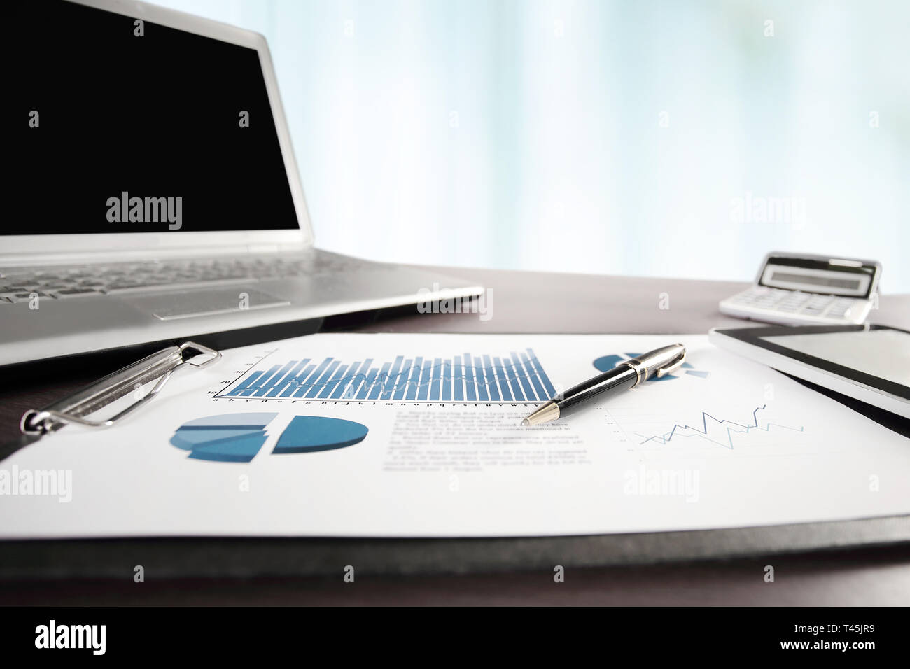 business background. the financial report is on the Desk . photo with ...