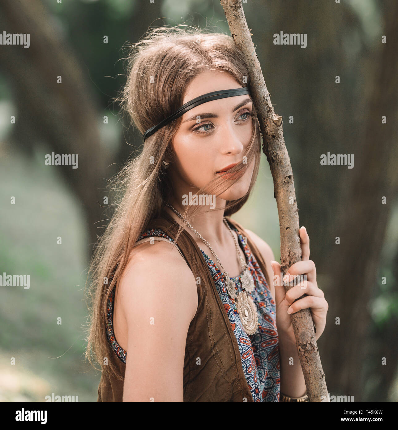 portrait of a beautiful woman hippies in a forest . the concept of ...