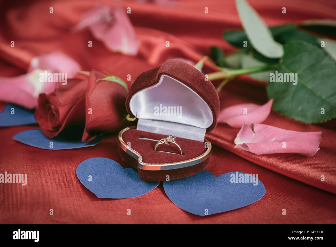 ring with a diamond on a red background . photo with copy space Stock ...