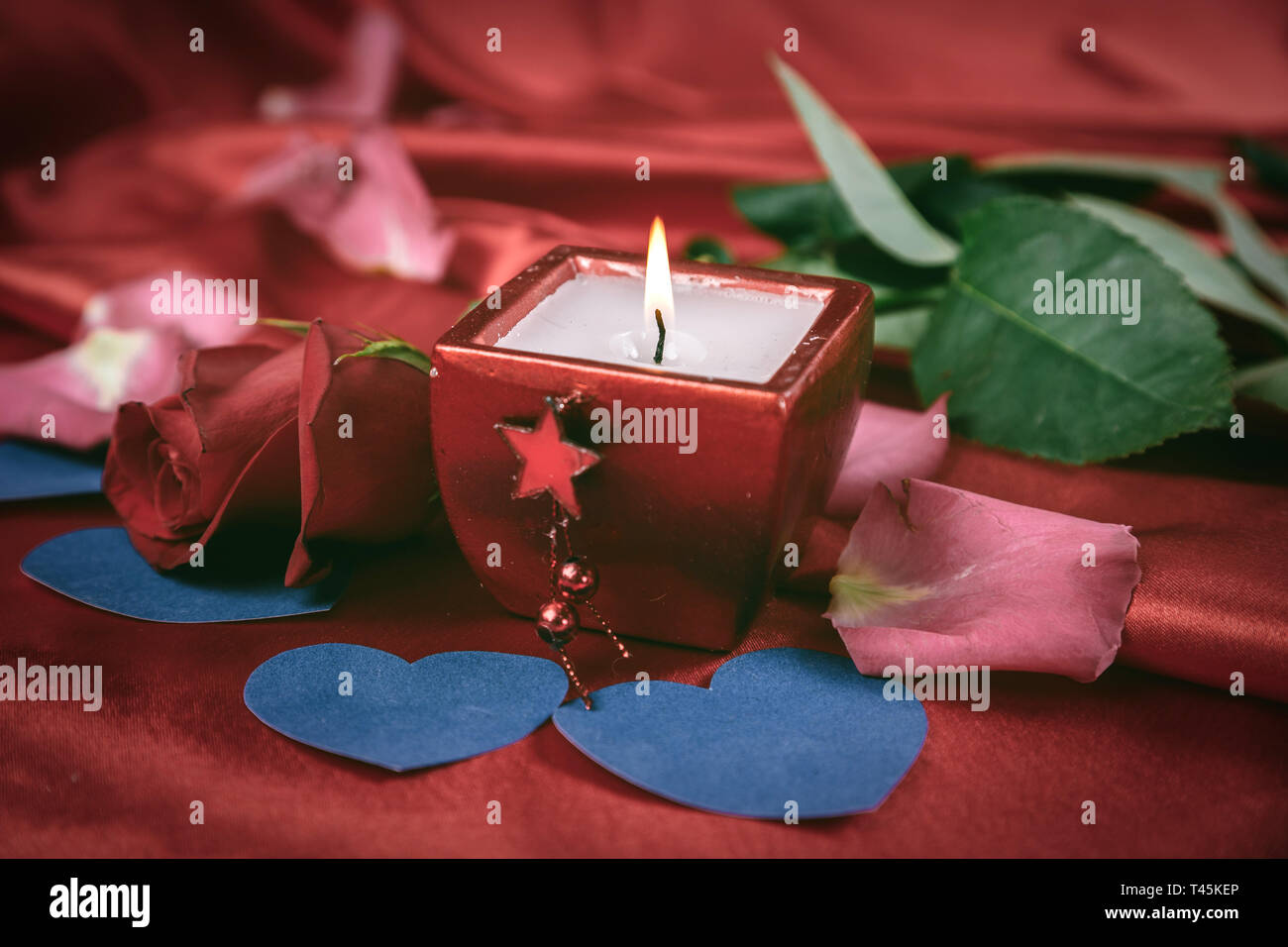 candle and rose on red silk background. photo with copy space Stock ...