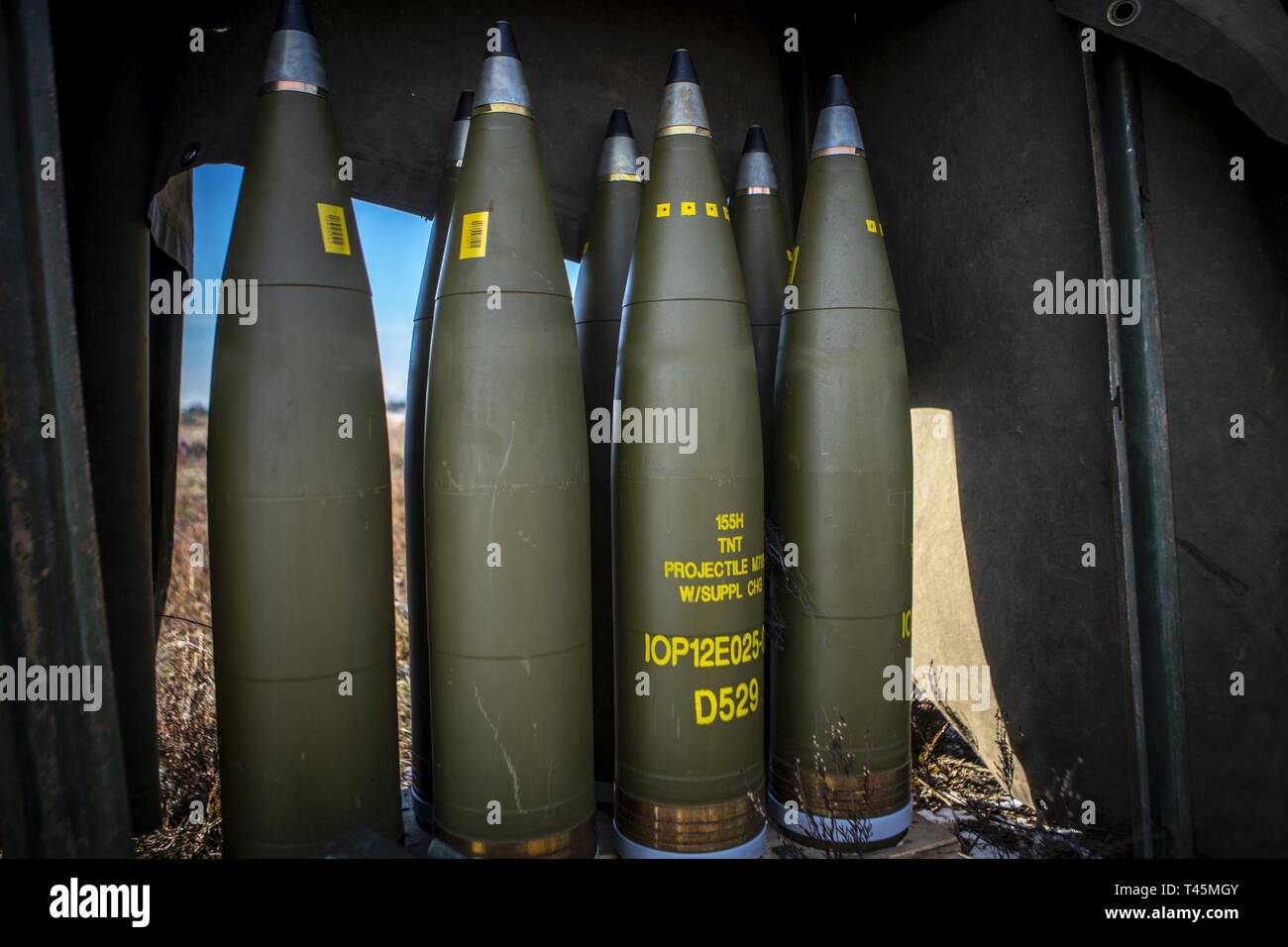 M795 155mm projectiles stand by a M777 howitzer at Adazi Training Area ...