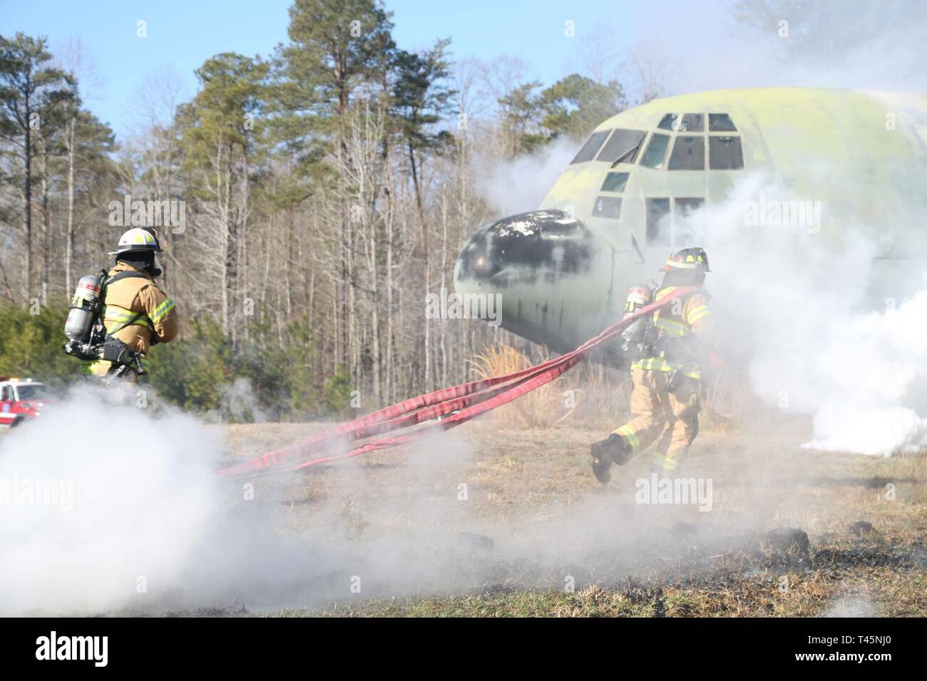 U.S. Firefighters extinguishes a fire during a Hercules Hill & Spill ...