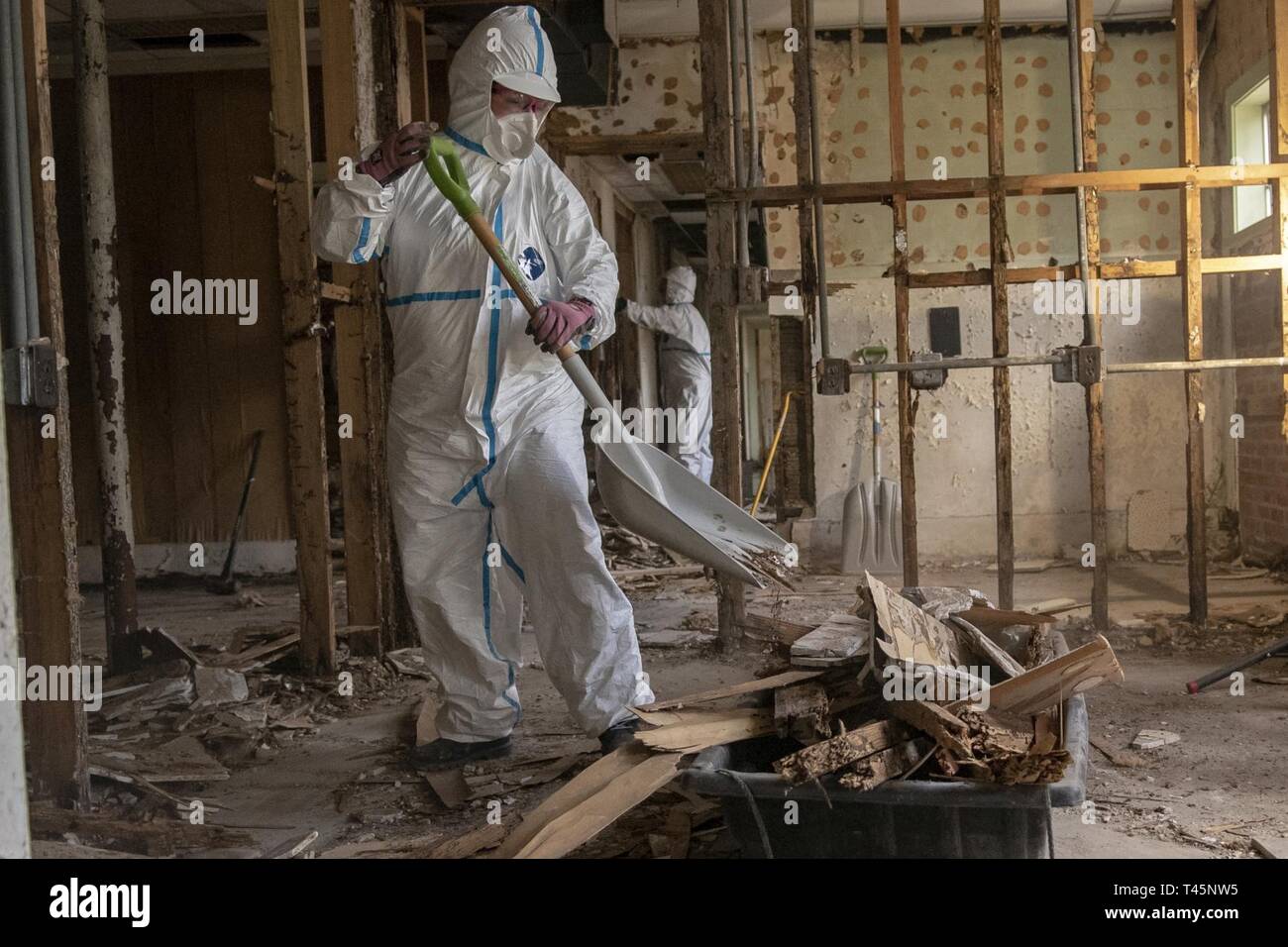 Members of Team Rubicon muck out a water-damaged structure at the ...