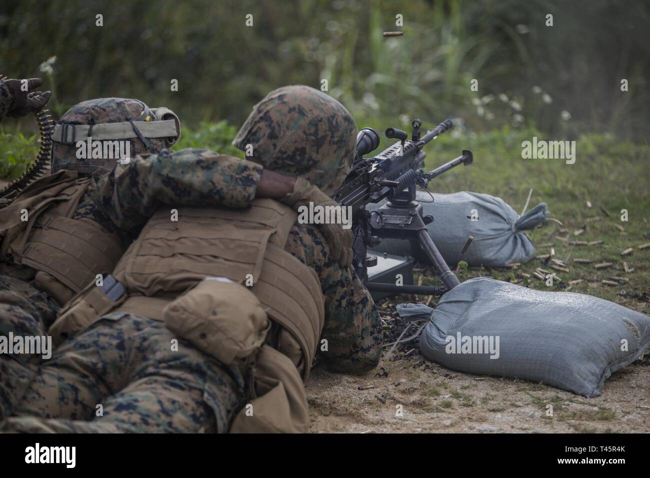 Marines with Combat Logistics Battalion 31 fire an M249 squad automatic ...