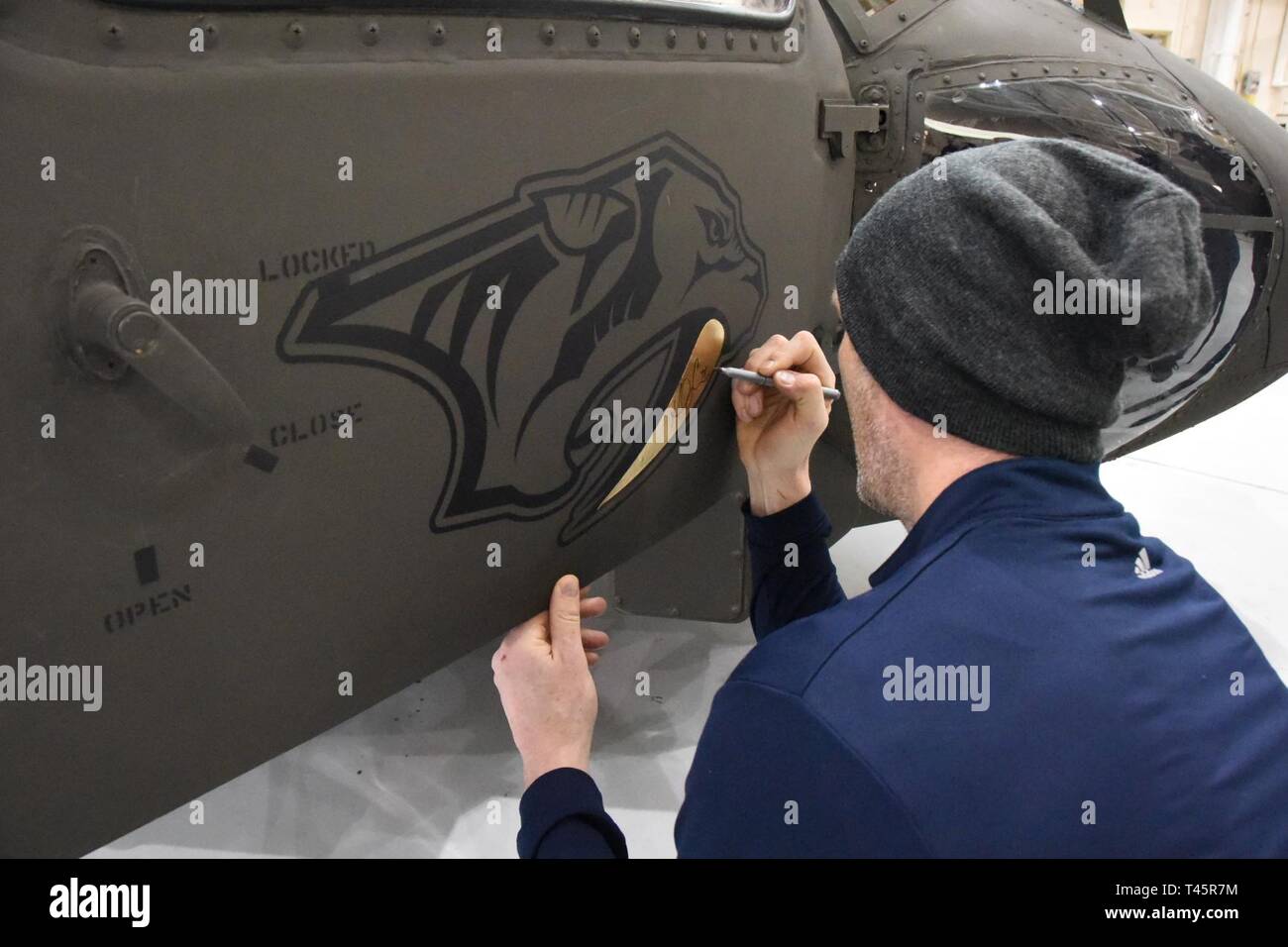 Hal Gill, a broadcaster with the Nashville Predators, signs the ...