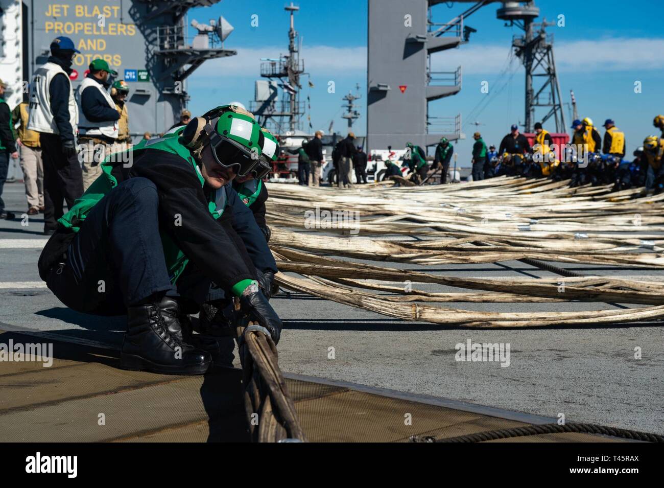 Va. (March 7, 2019) Sailors rig a barricade during flight deck drills ...