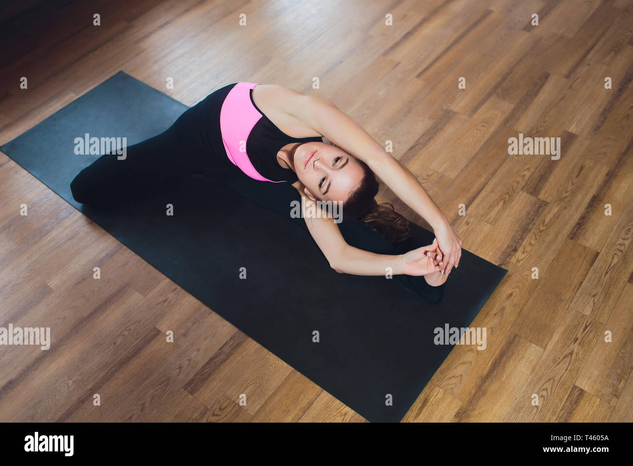 Young woman practicing yoga, stretching in variation of Reverse Table ...