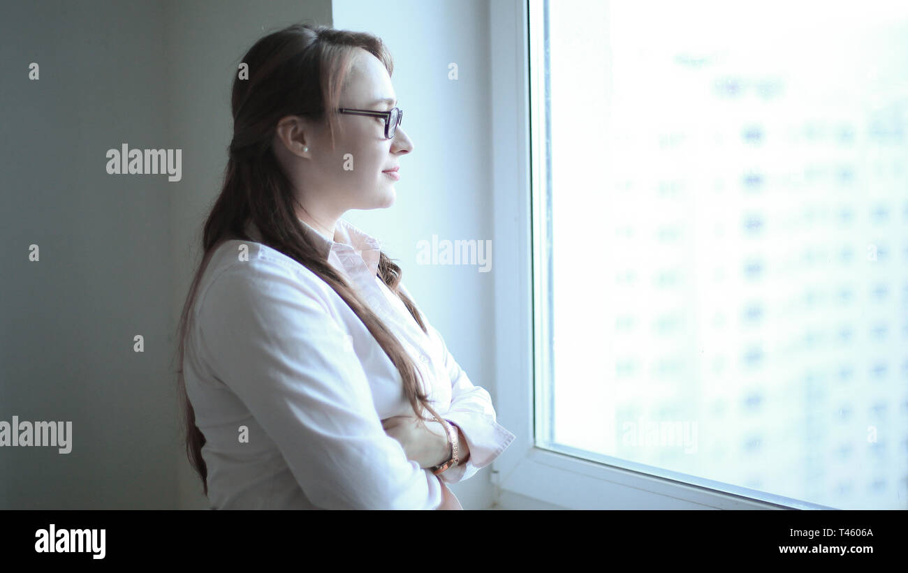 Executive business woman looking out the office window.photo with copy ...