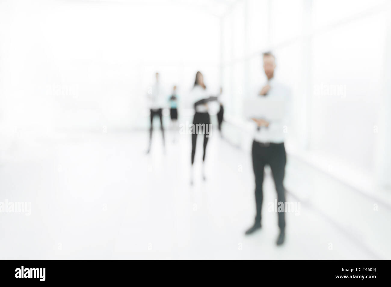 blurred image of employees standing in the office lobby .business ...